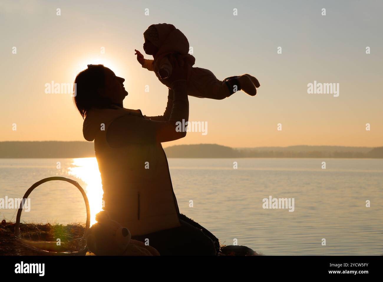 A joyful and touching moment between parents and children by the water ...
