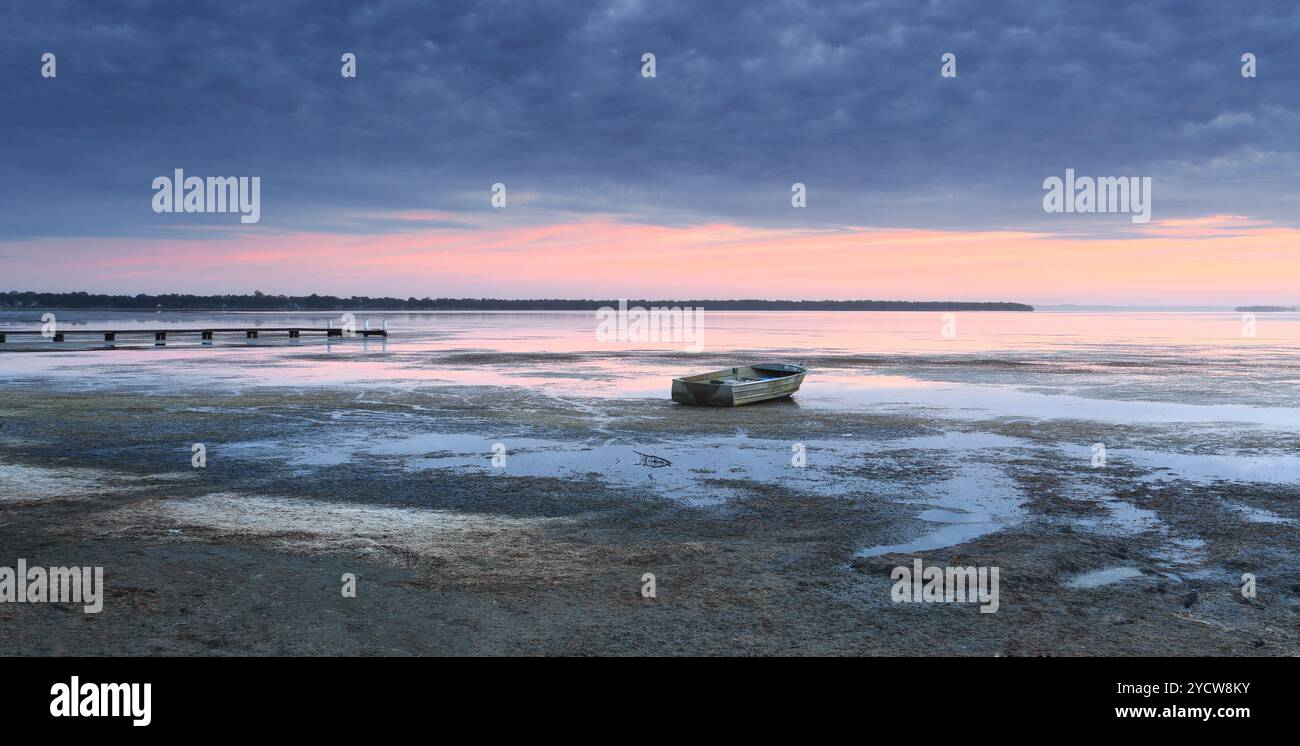 Little old dinghy (tinnie) in the colourful shallows of the estruary ...