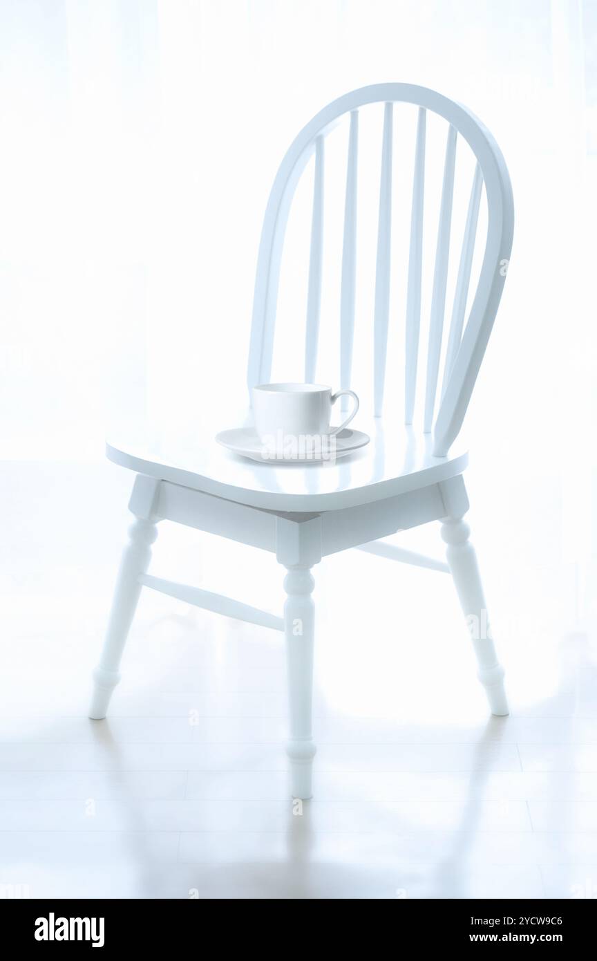 Coffee cup and chair Stock Photo - Alamy
