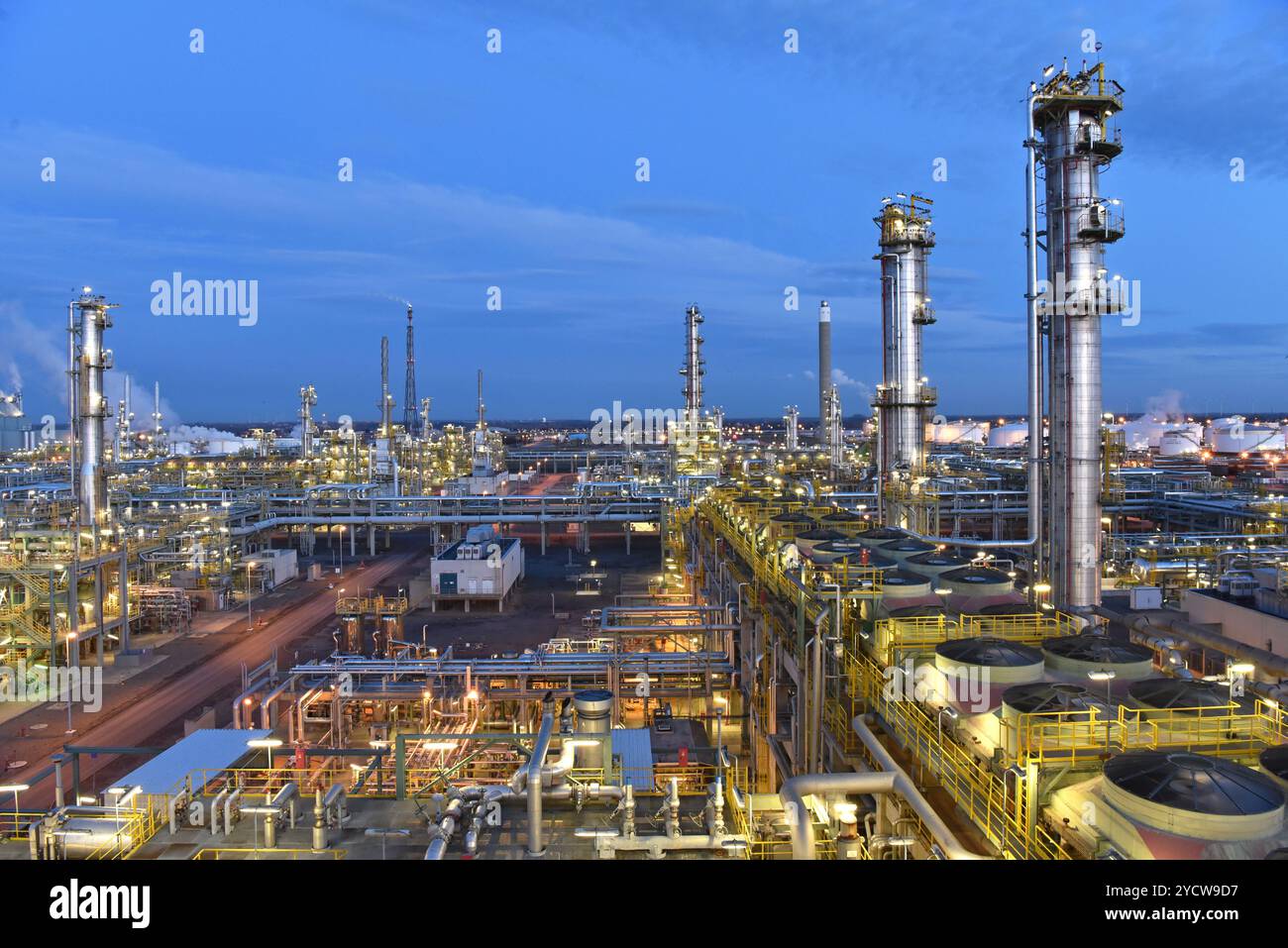 refinery - chemical factory at night with buildings, pipelines and ...