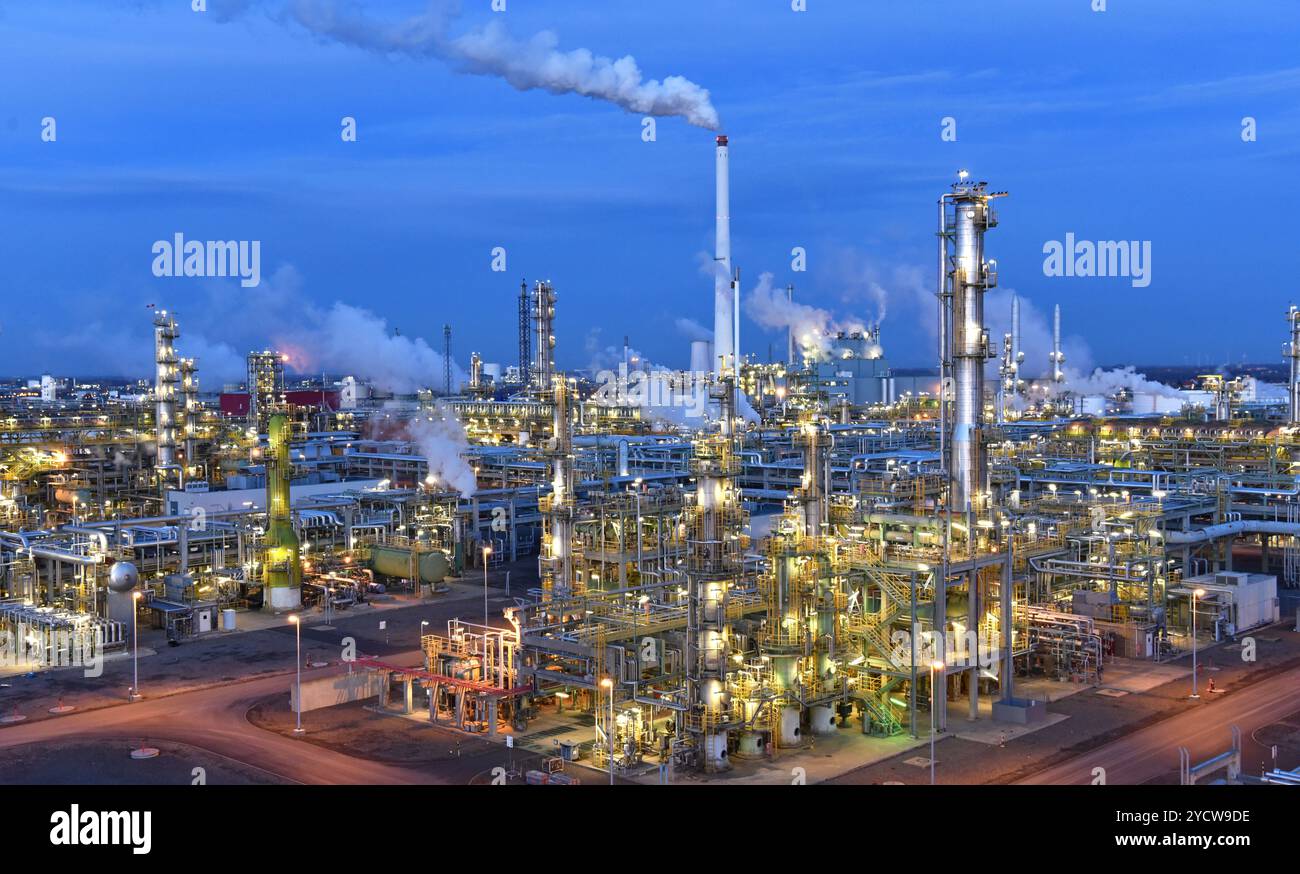refinery - chemical factory at night with buildings, pipelines and ...