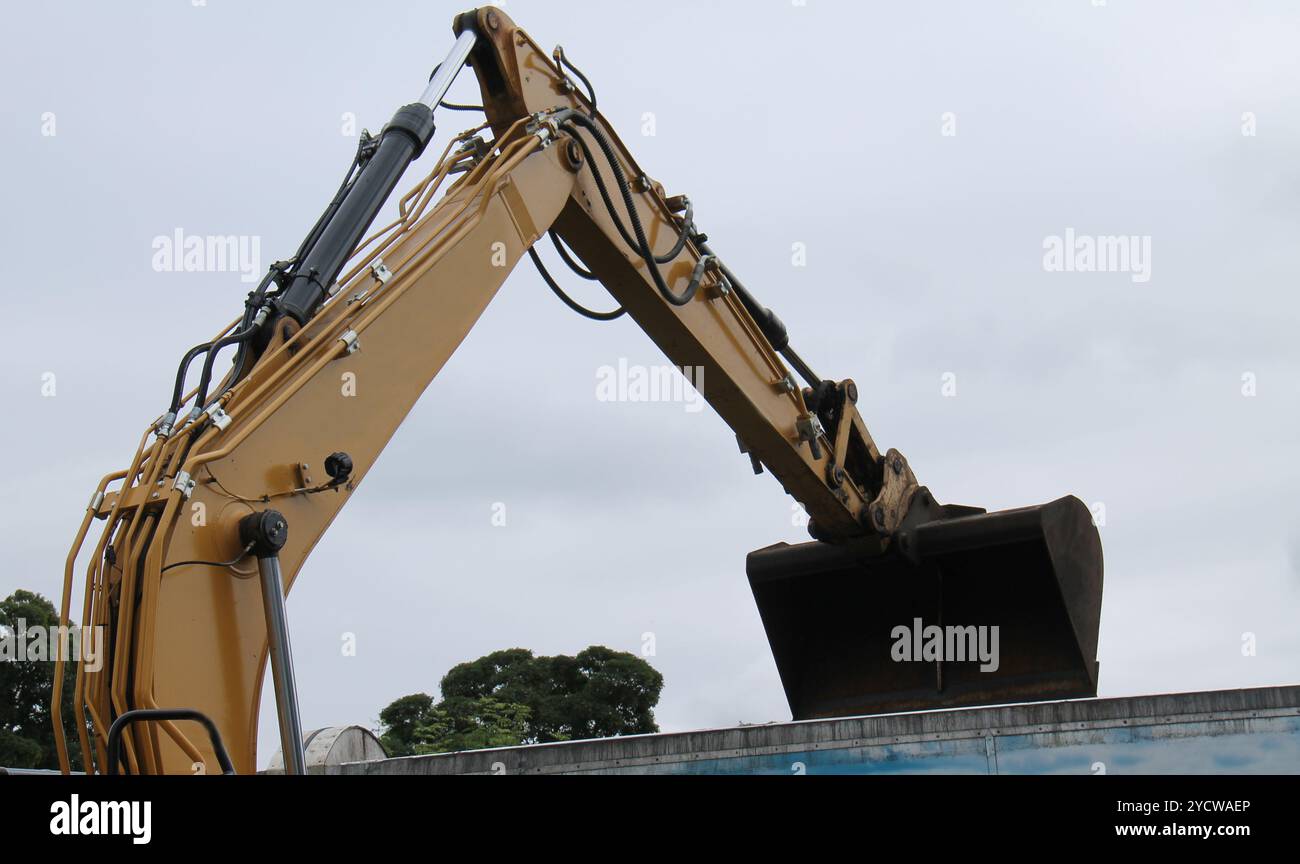 A Hydraulic Excavator Digger Working with a Tipper Lorry Stock Photo ...