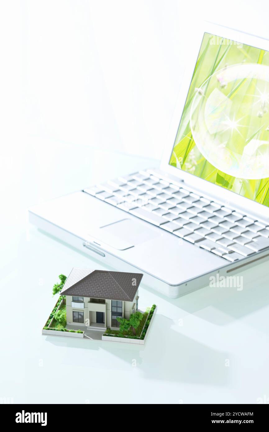 Laptops and house models Stock Photo - Alamy