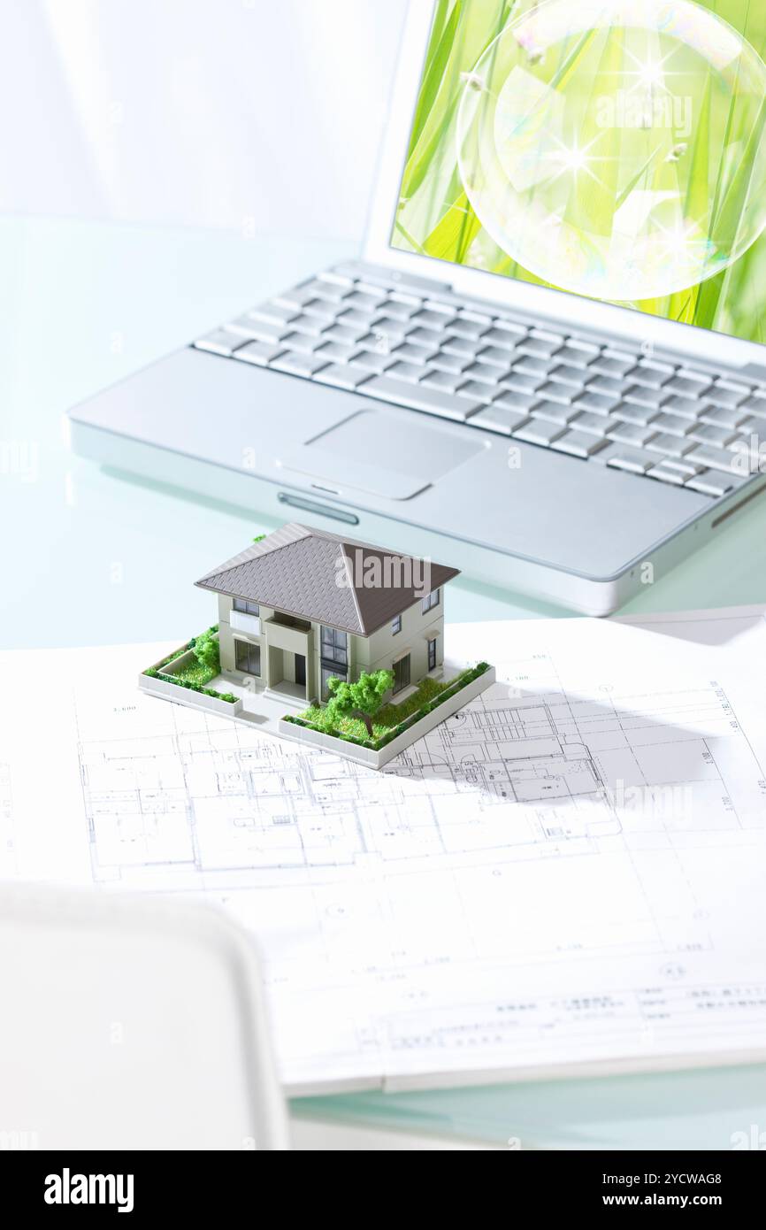 Laptops and house models Stock Photo - Alamy