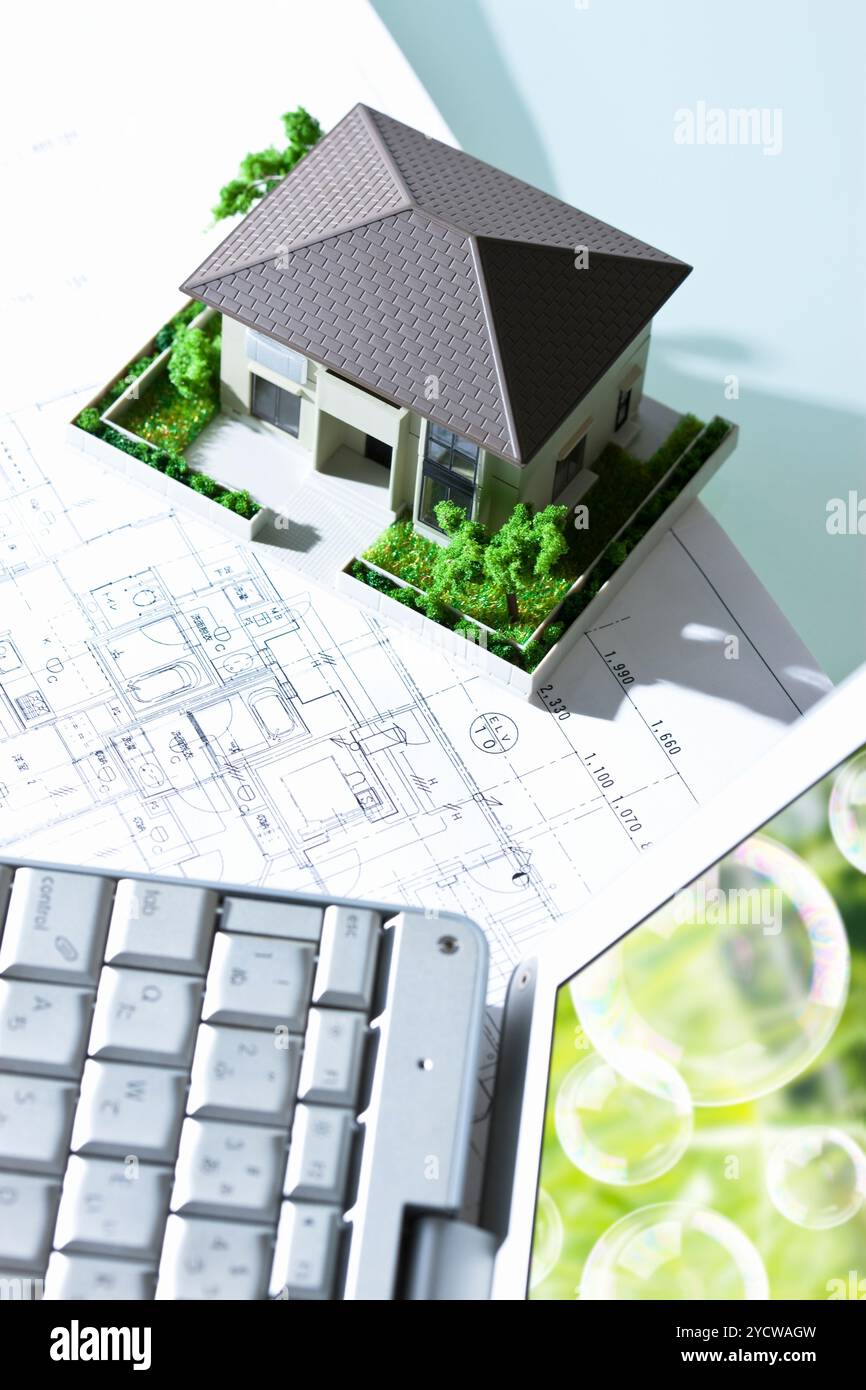 Laptops and house models Stock Photo - Alamy