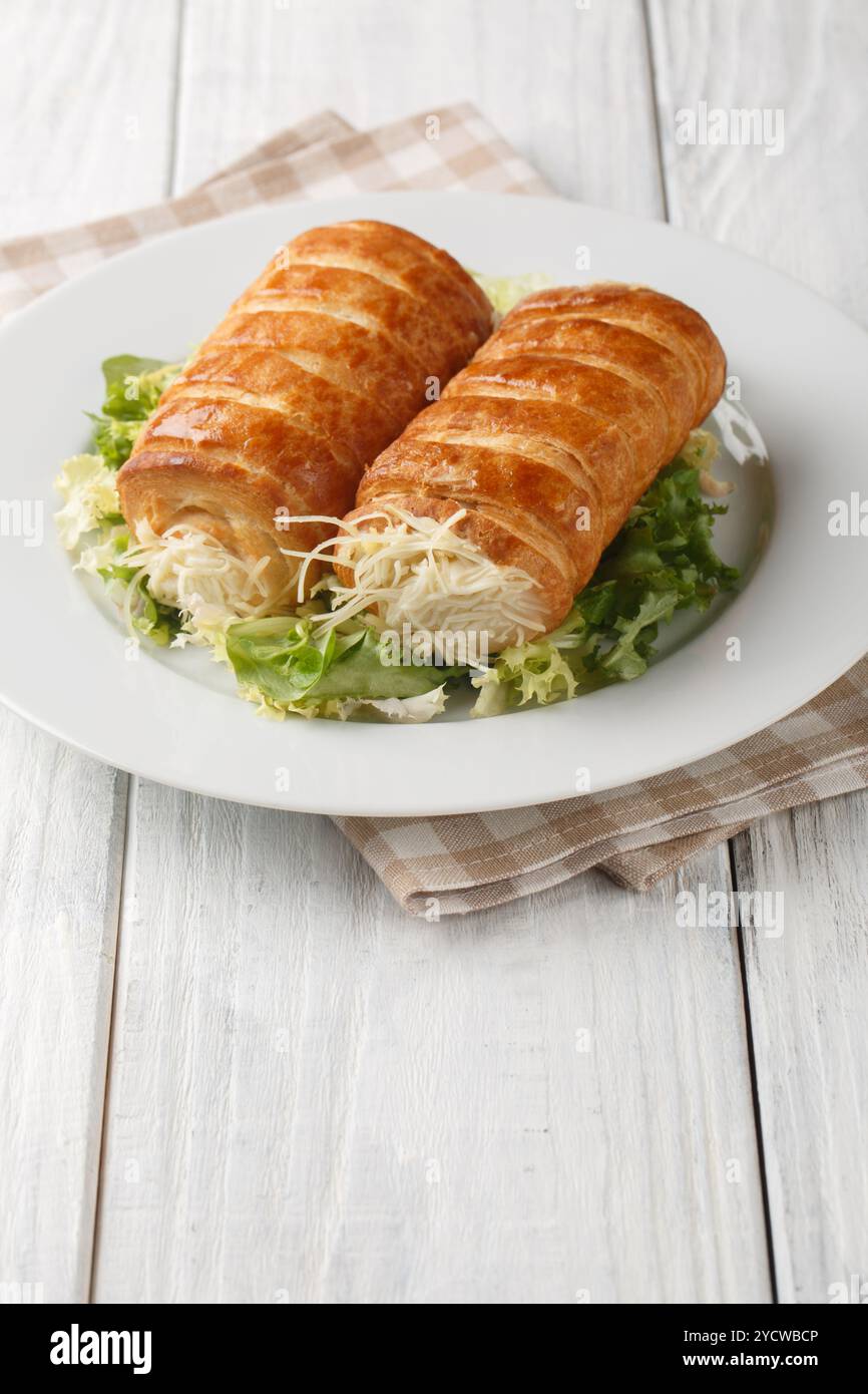 French puff pastry tubes stuffed with bechamel cheese sauce close-up in ...