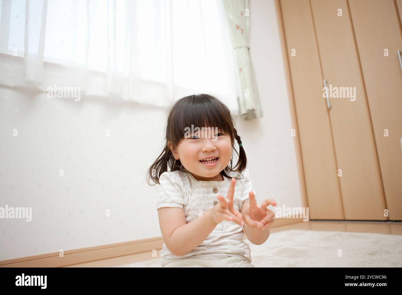 Girl making peace sign Stock Photo - Alamy