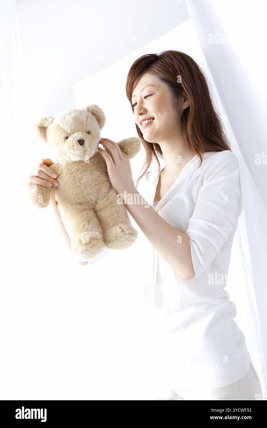Woman holding stuffed animal Stock Photo - Alamy