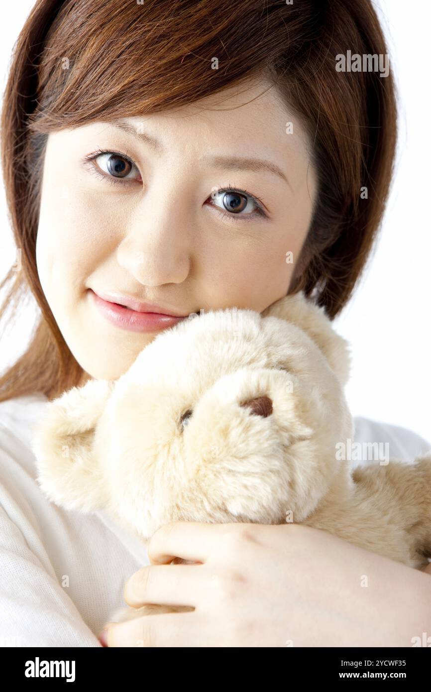 Woman holding stuffed animal Stock Photo - Alamy
