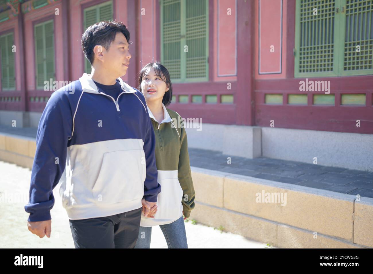 A Korean couple, a man in his 30s and a woman in her 20s, walks ...