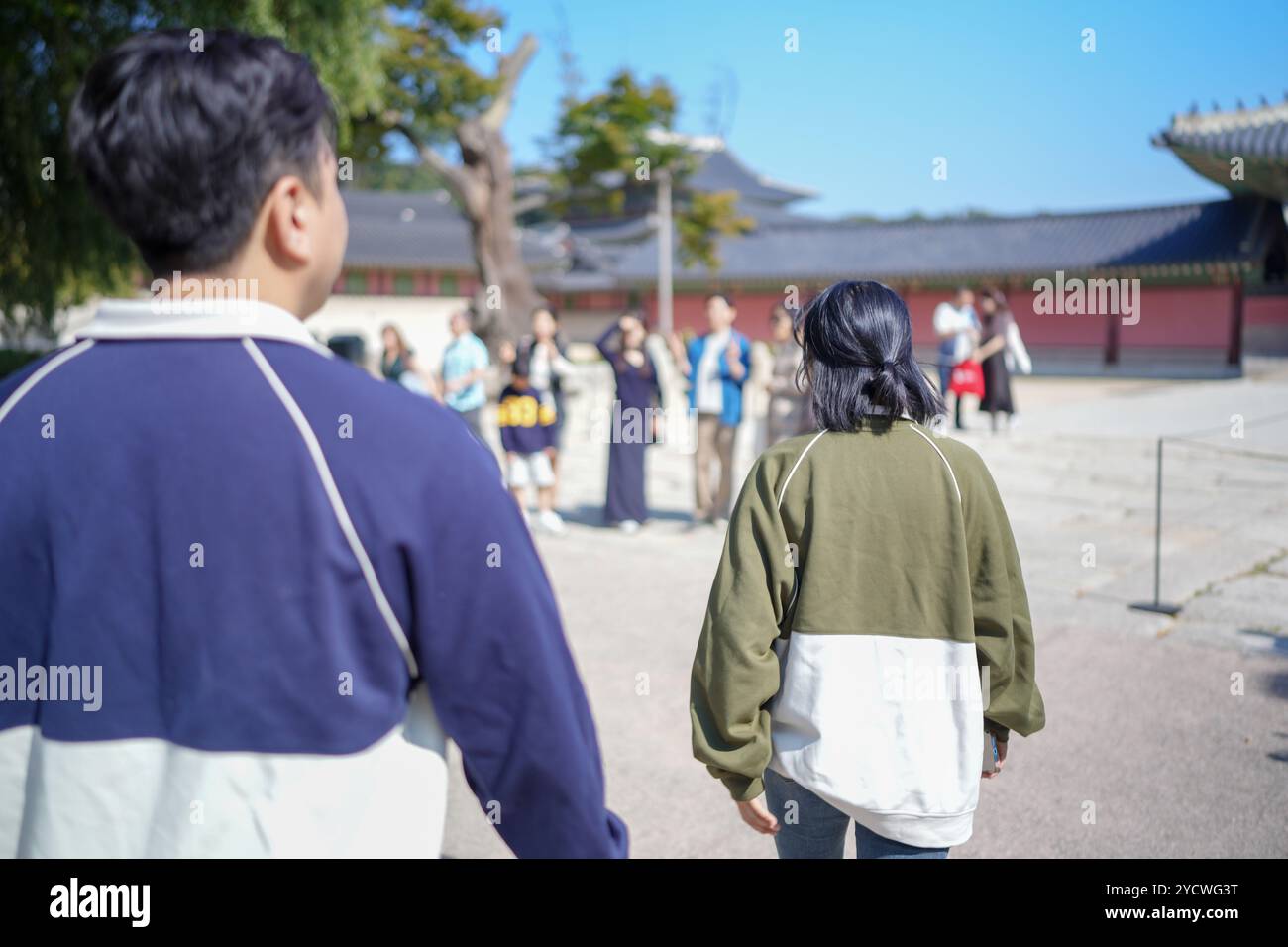 A Korean couple, a man in his 30s and a woman in her 20s, walks ...