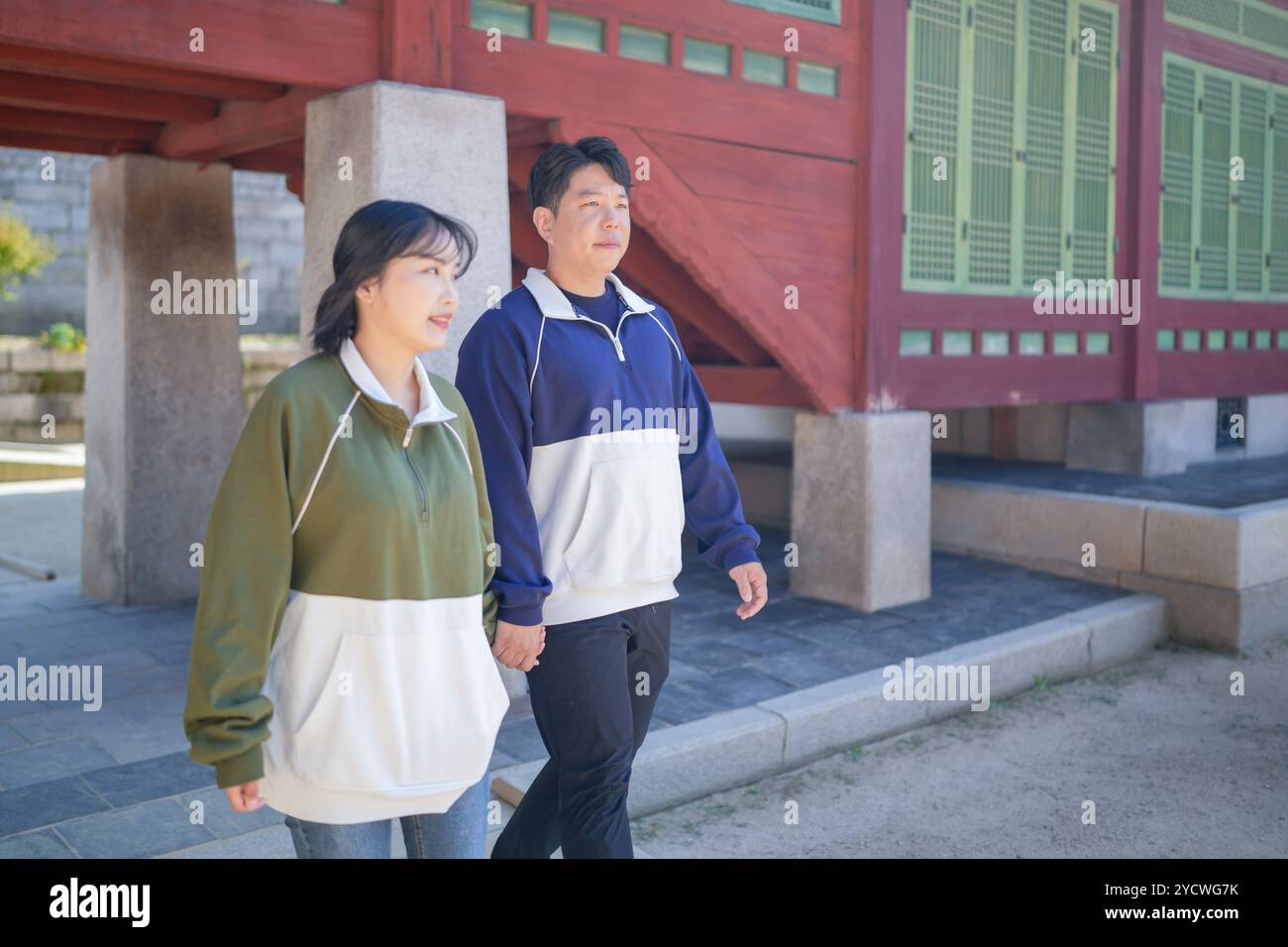 A Korean couple, a man in his 30s and a woman in her 20s, walks ...