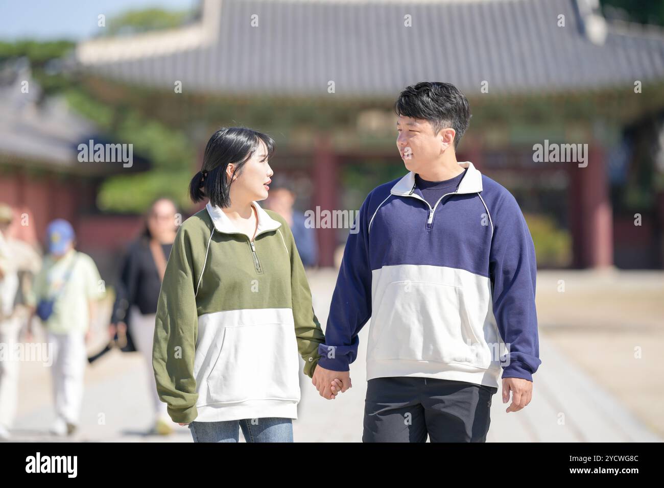A Korean couple, a man in his 30s and a woman in her 20s, walks ...