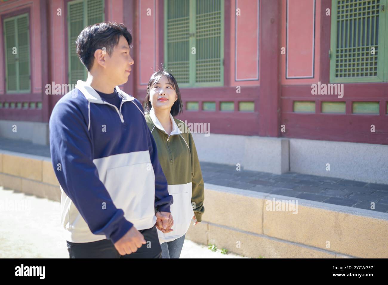 A Korean couple, a man in his 30s and a woman in her 20s, walks ...