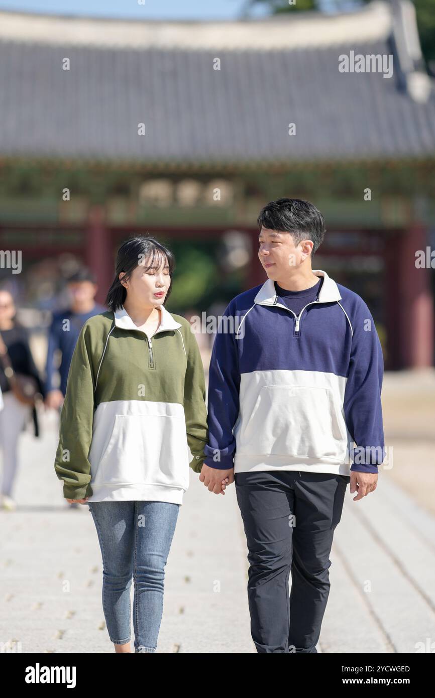 A Korean couple, a man in his 30s and a woman in her 20s, walks ...