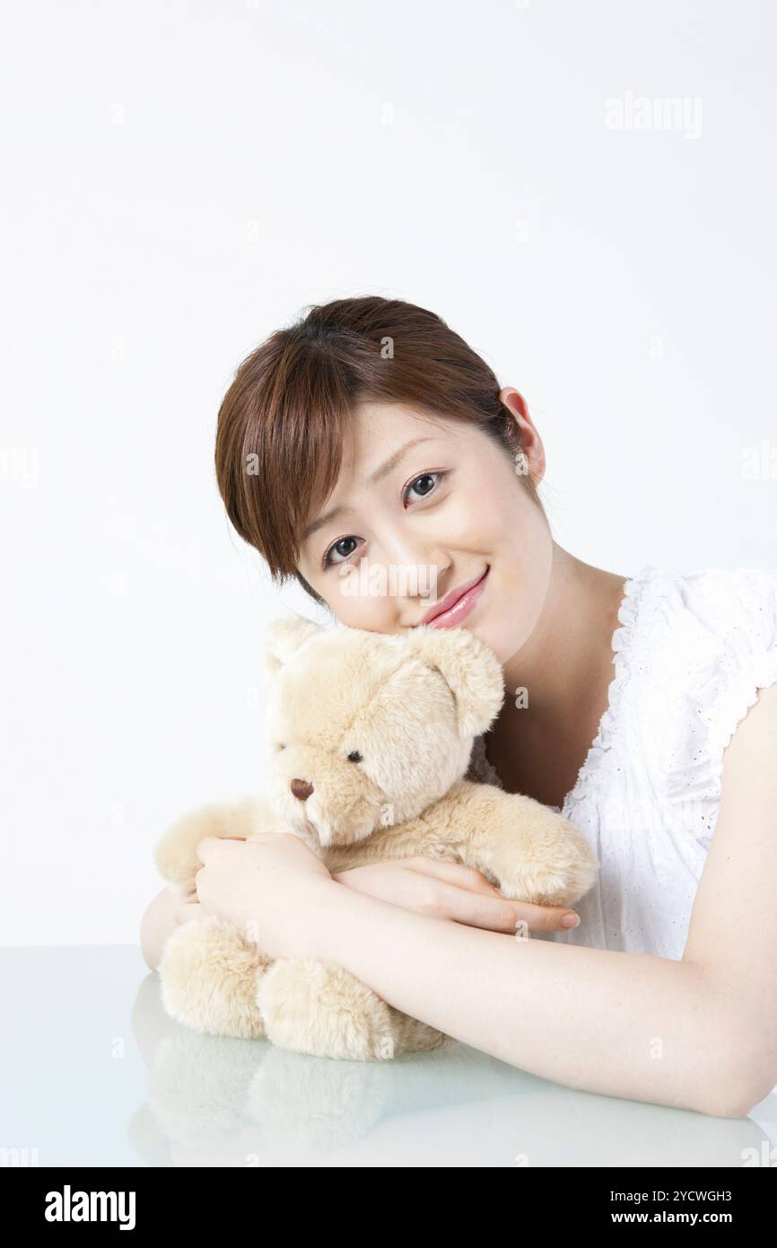 Woman holding stuffed animal Stock Photo - Alamy