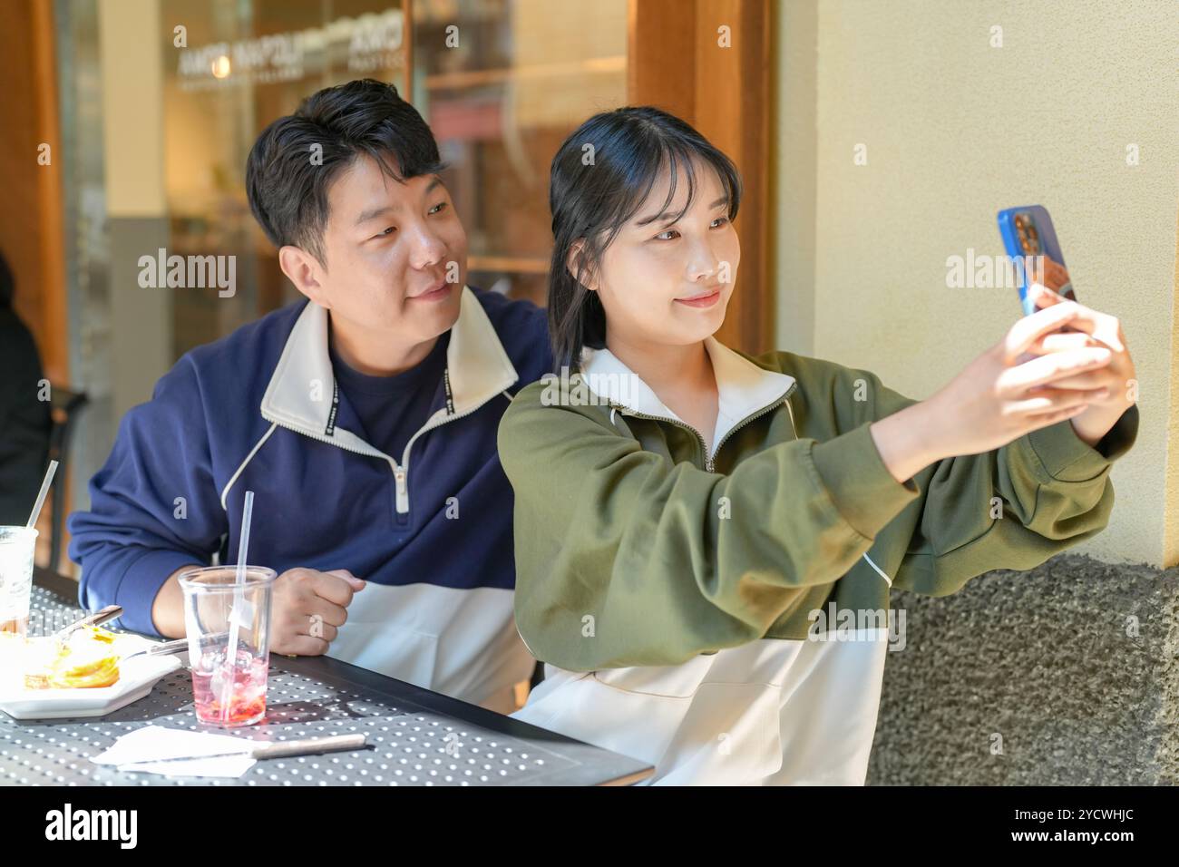 A couple, a Korean man in his 30s and a woman in her 20s, wear ...