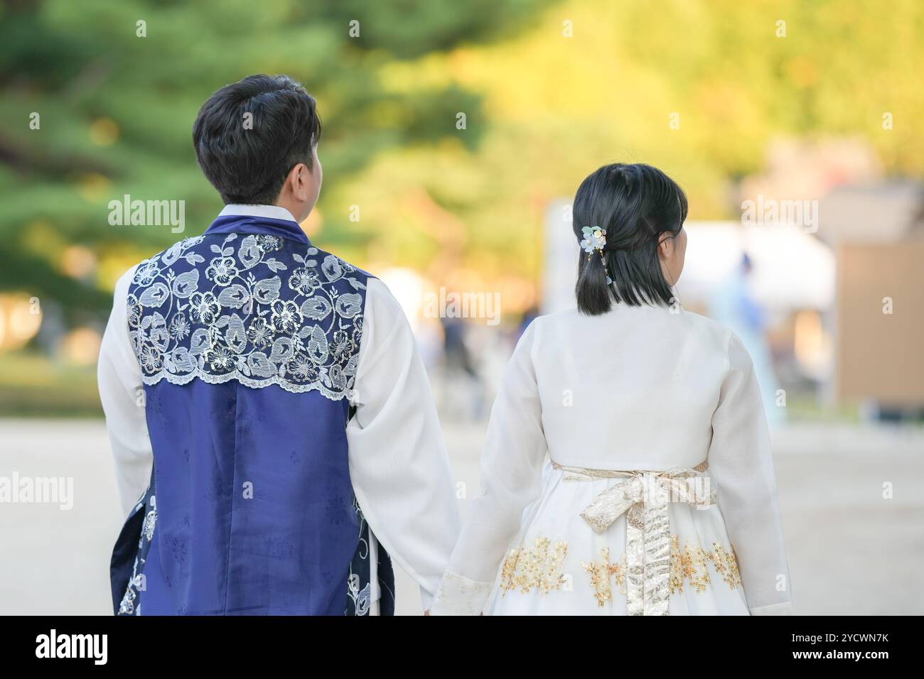 A Korean couple, a man in his 30s and a woman in her 20s, walks ...