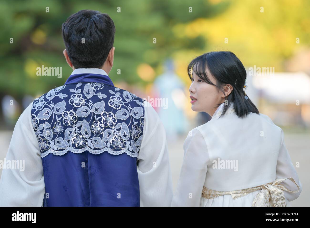A Korean couple, a man in his 30s and a woman in her 20s, walks ...