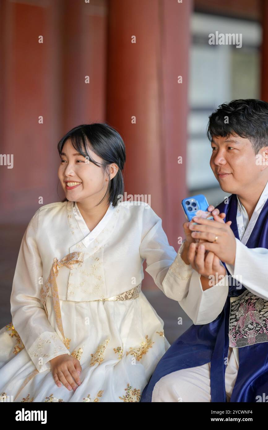 A Korean couple, a man in his 30s and a woman in her 20s, are happily ...