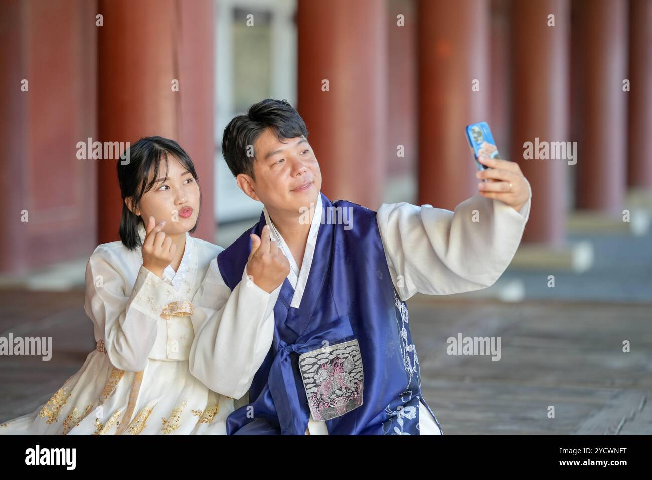 A Korean couple, a man in his 30s and a woman in her 20s, are happily ...