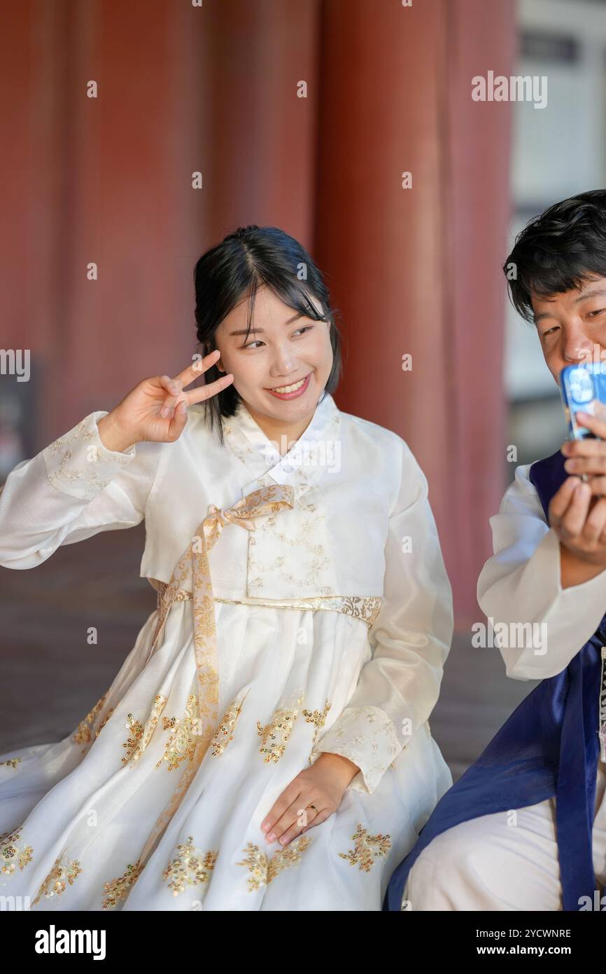 A Korean couple, a man in his 30s and a woman in her 20s, are happily ...