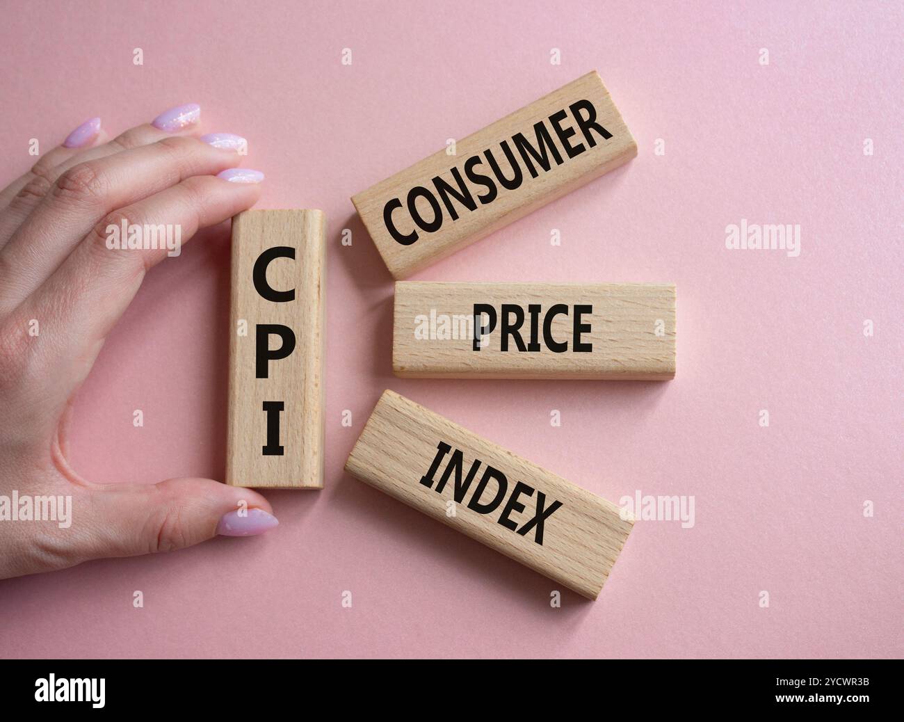 CPI - Consumer Price Index symbol. Concept word CPI on wooden blocks. Businessman hand ...