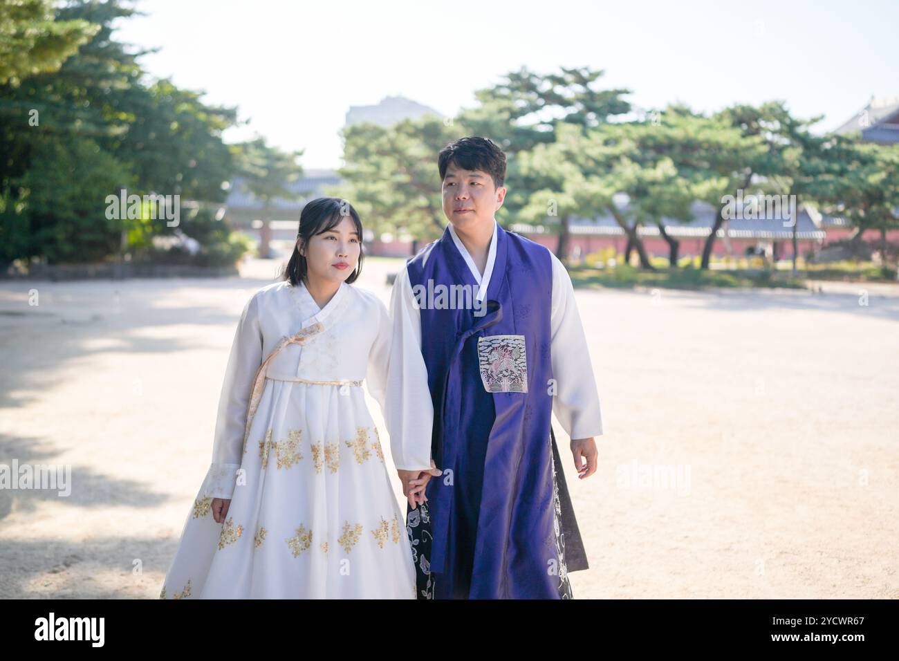 A Korean couple, a man in his 30s and a woman in her 20s, walks ...