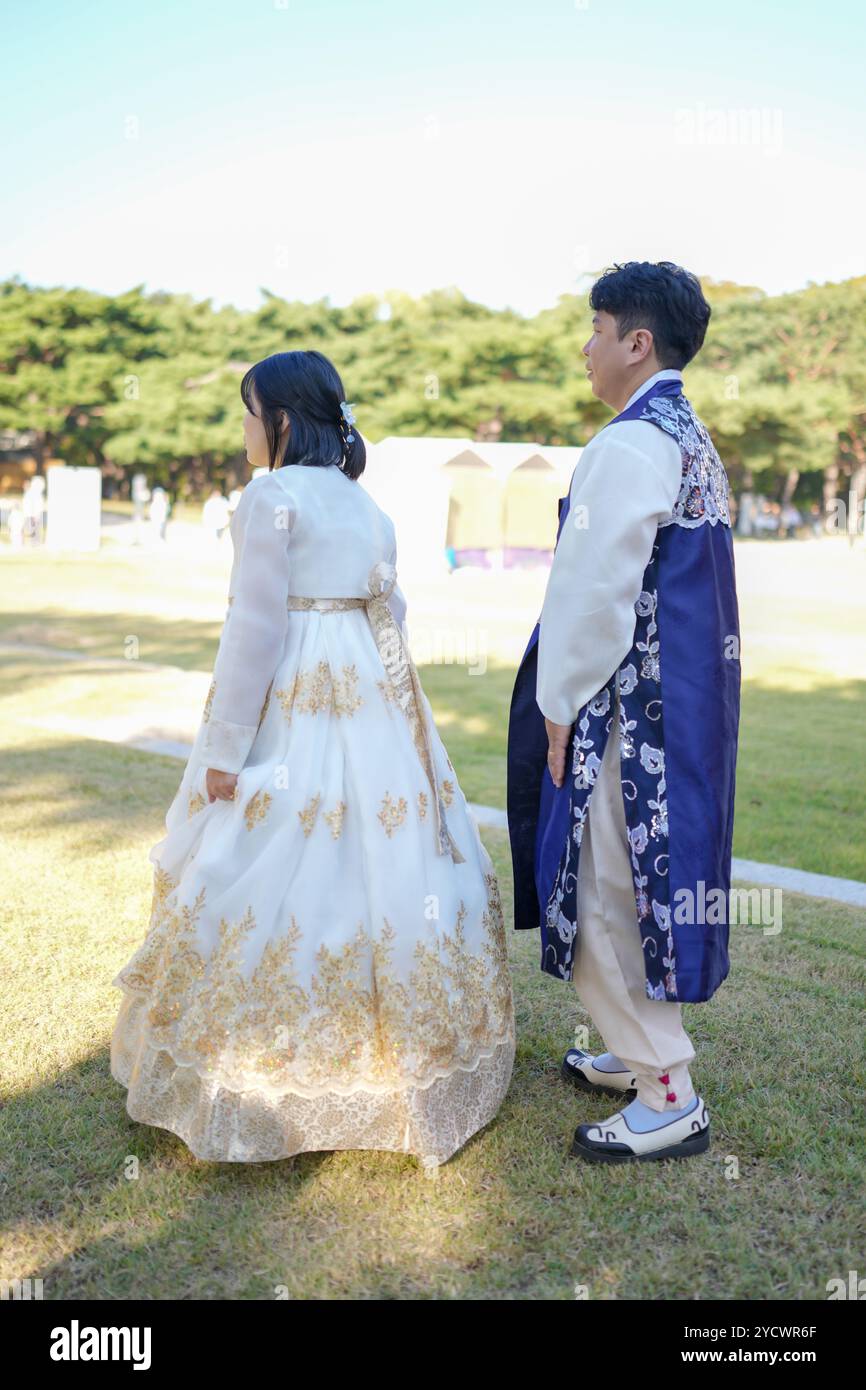 A Korean couple, a man in his 30s and a woman in her 20s, walks ...