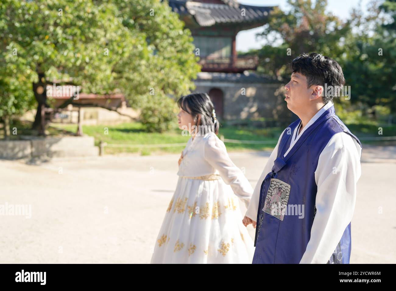 A Korean couple, a man in his 30s and a woman in her 20s, walks ...
