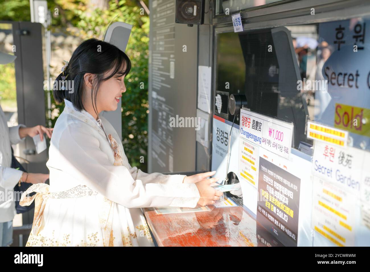 A Korean couple in their 20s buys tickets at a historical building in ...
