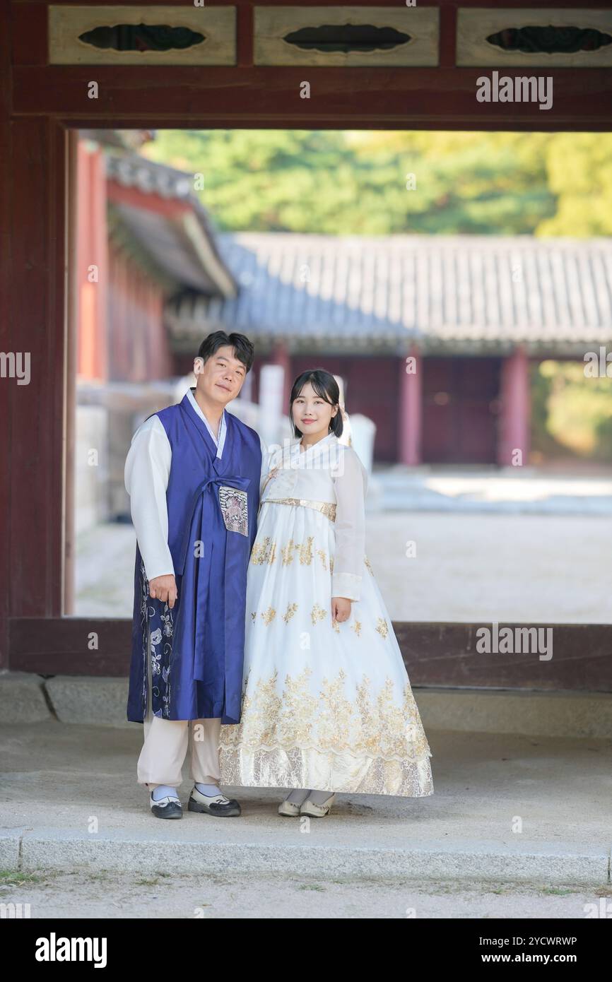 A Korean couple in their 30s and a woman in their 20s stand together in ...