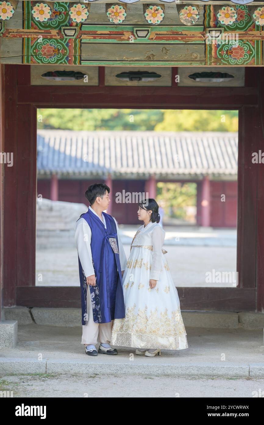 A Korean couple in their 30s and a woman in their 20s stand together in ...