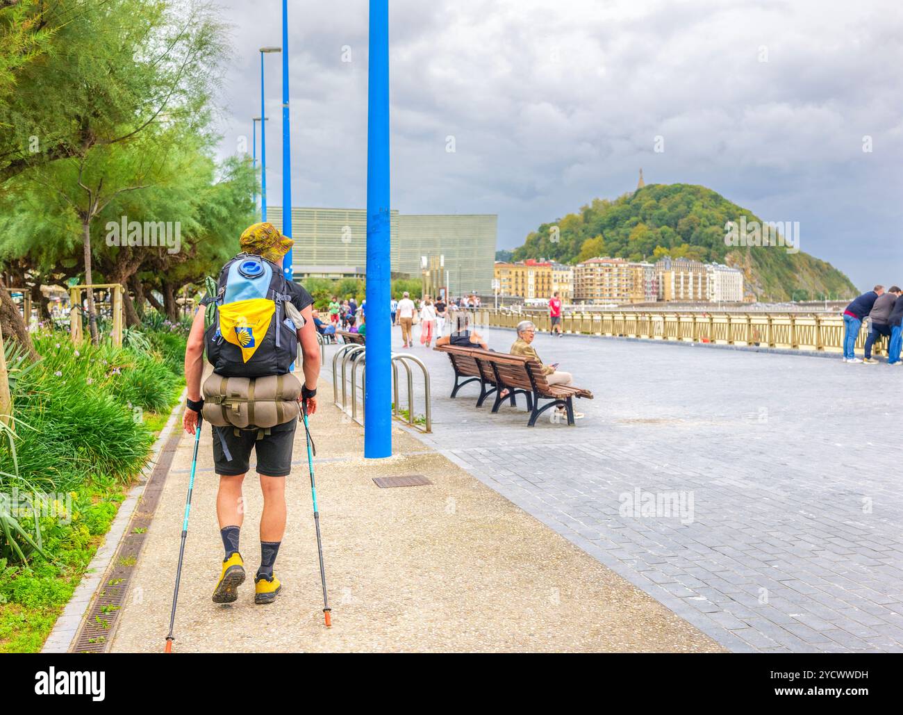 A pilgrim walking along the promenade of the Zurriola beach of San ...