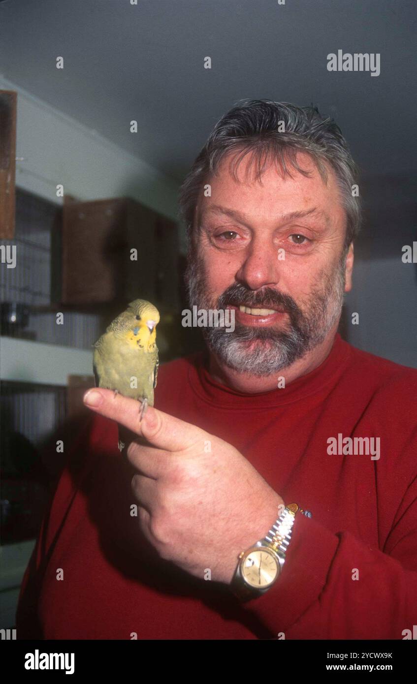 Geoff Capes with a budgerigar on his finger. He was a budgerigar ...
