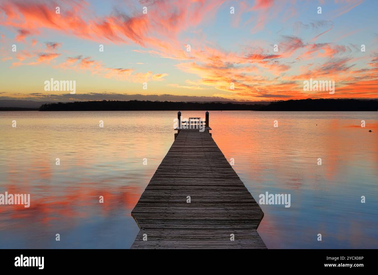 Sunset over St Georges Basin with timber jetty Stock Photo - Alamy