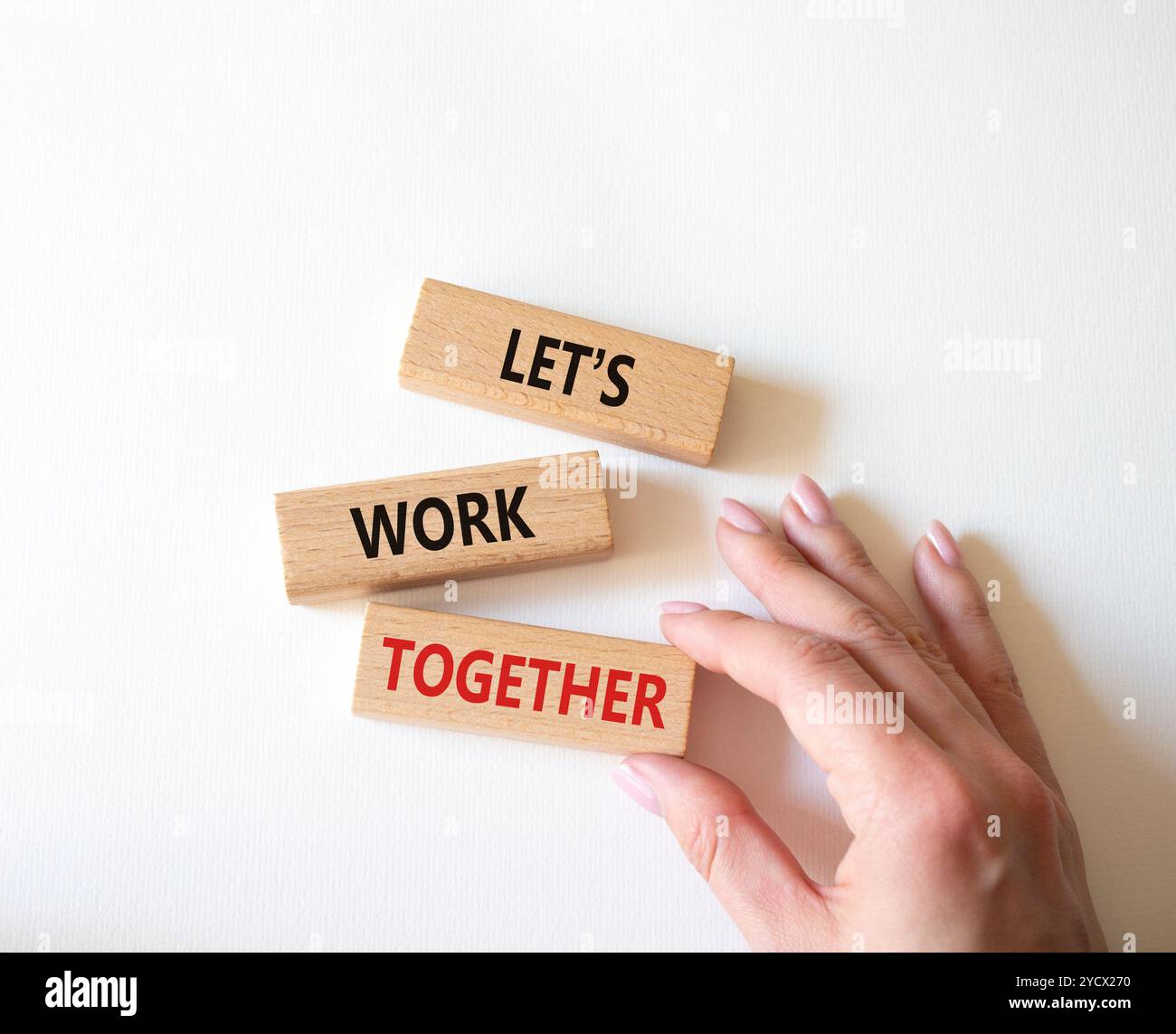 Lets work together symbol. Concept words Less is More on wooden blocks ...