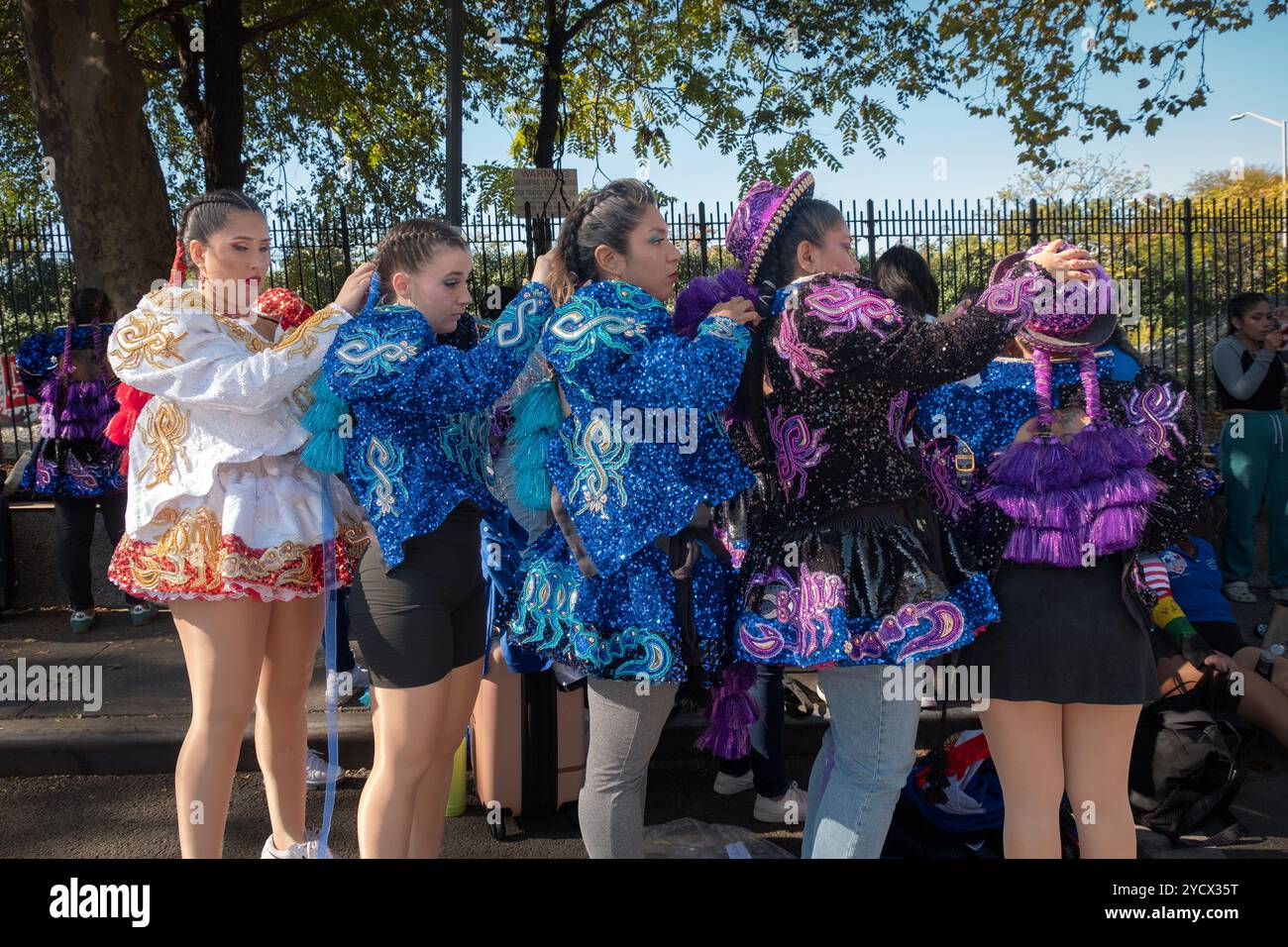 5 girls from the San Simon dance group adjust their hair and costumes ...