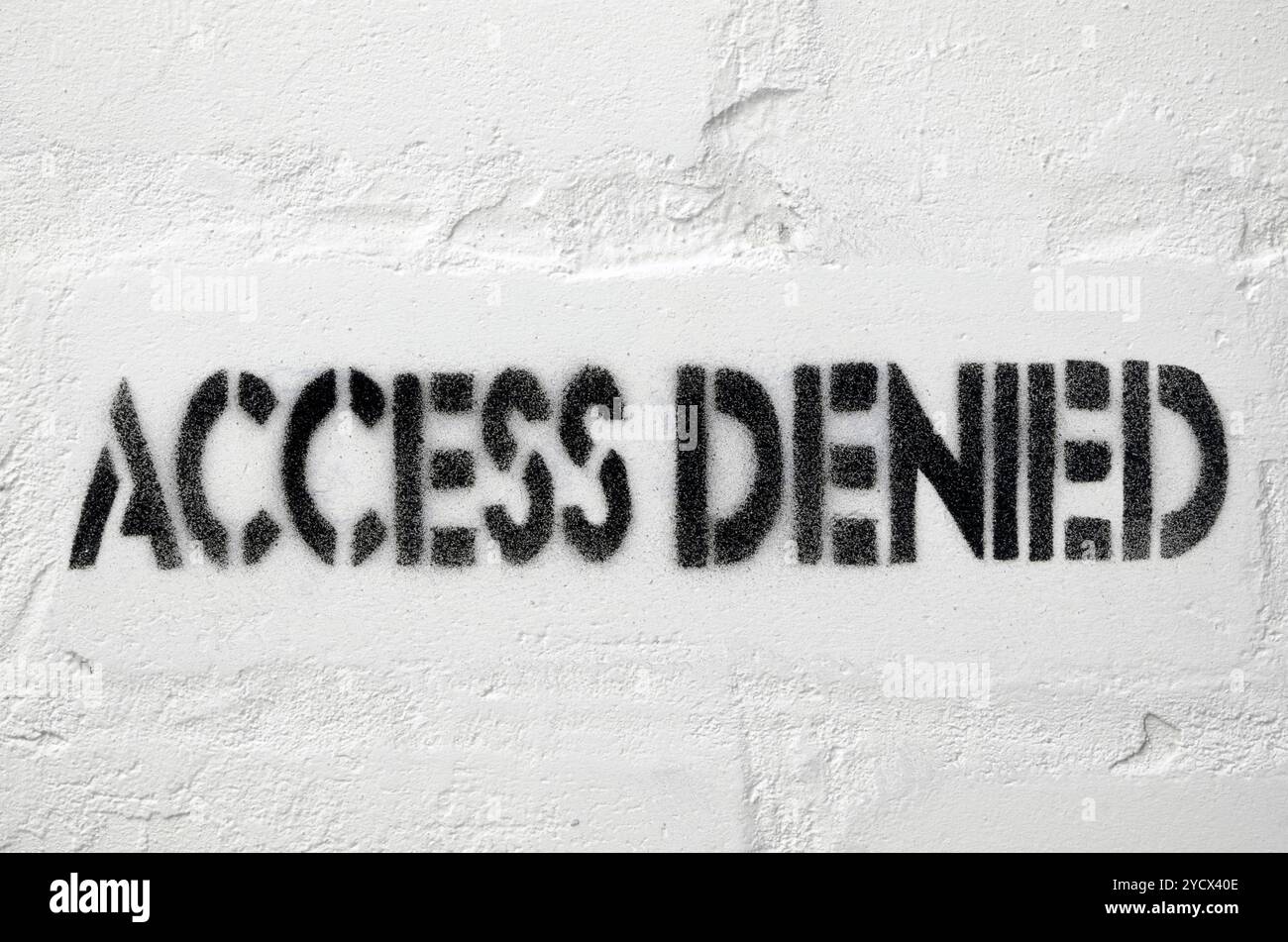 access denied black stencil print on the white brick wall Stock Photo ...