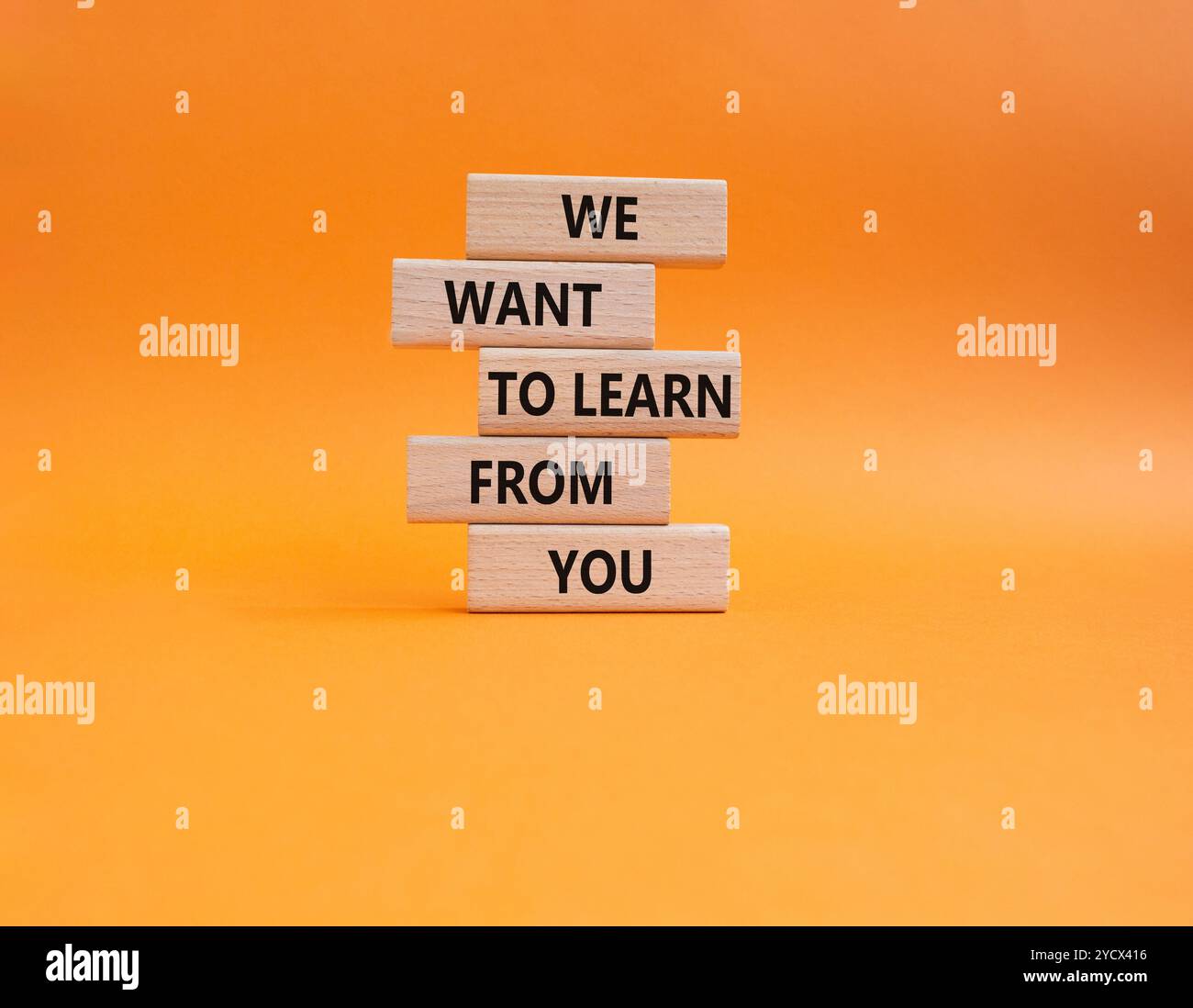 We want to learn from you symbol. Wooden blocks with words We want to ...