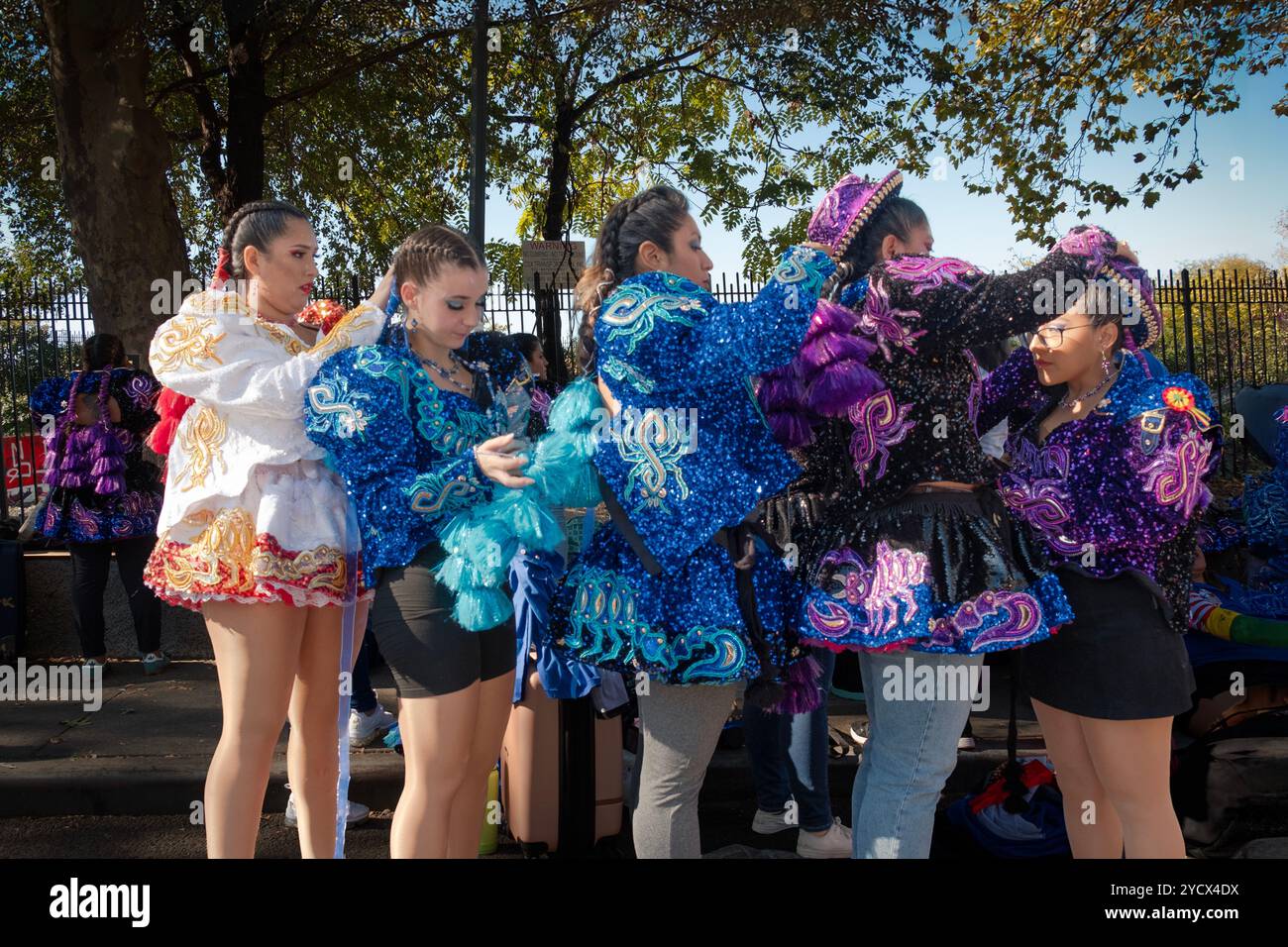 5 girls from the San Simon dance group adjust their hair and costumes ...