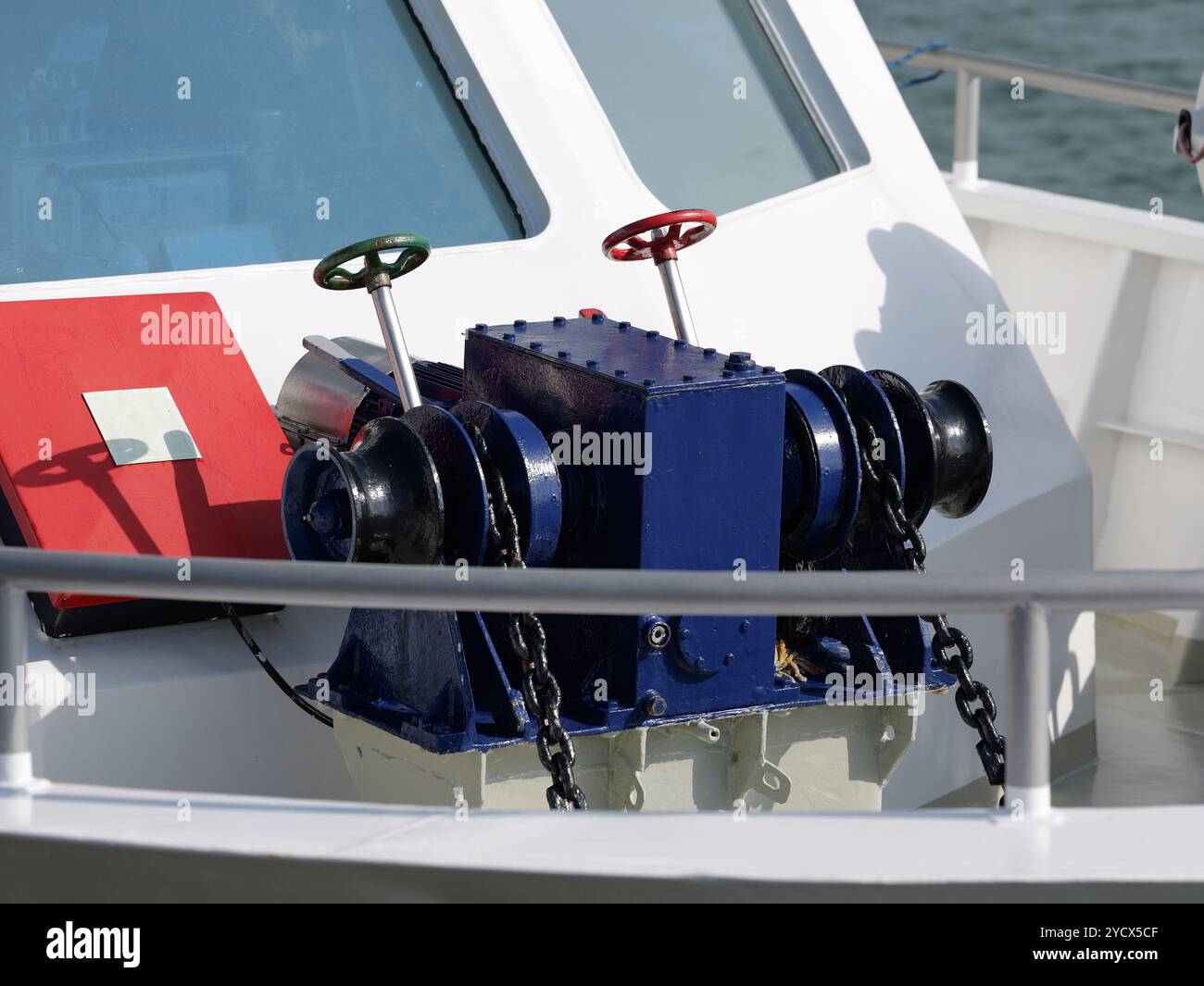 The detail of the anchor winch, with its blue locking block and massive ...