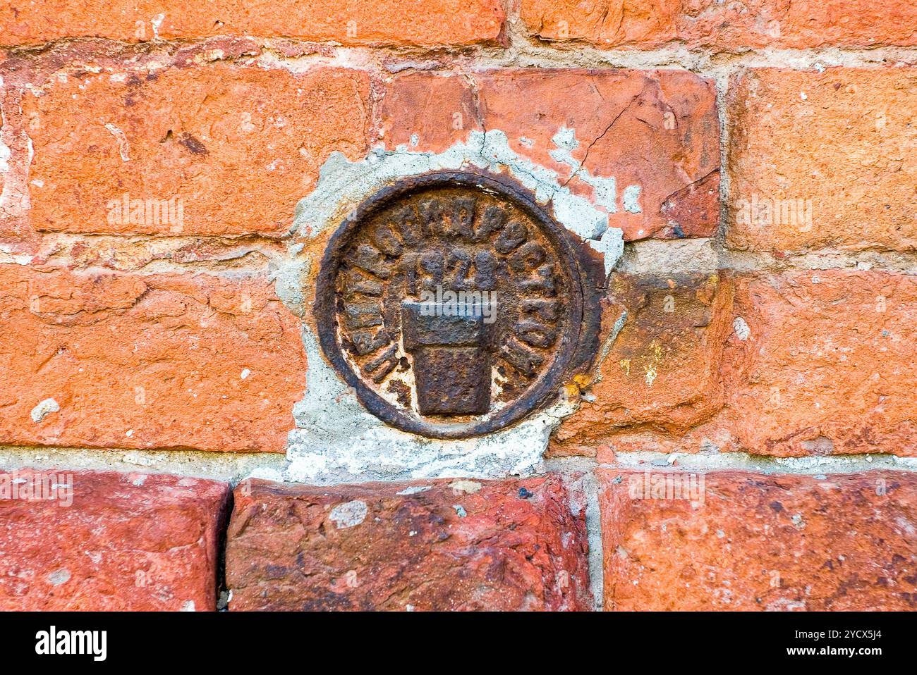 Vintage Russian government survey marker (benchmark disk) in the wall ...