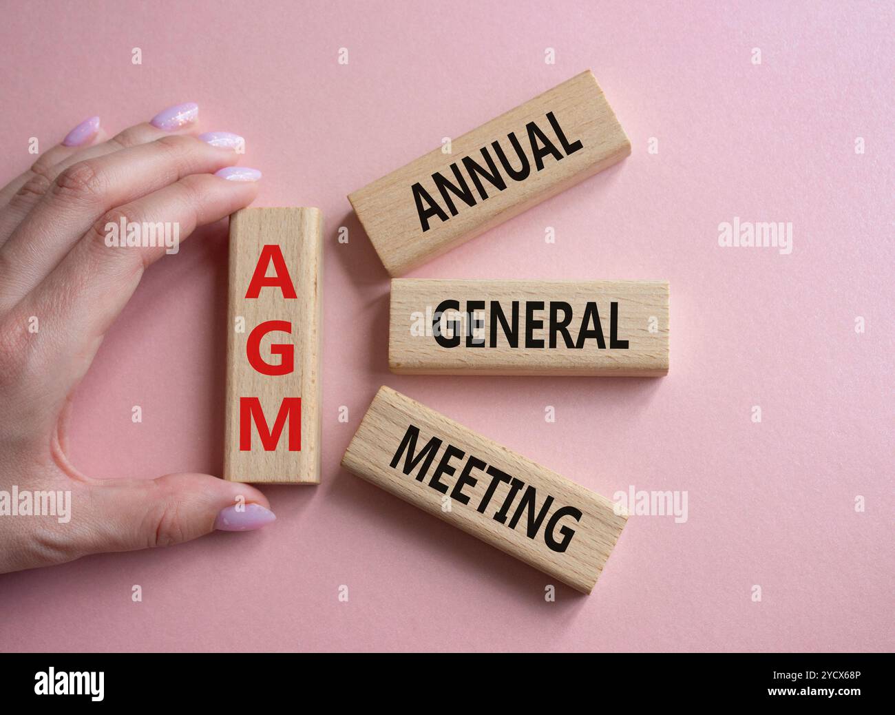 AGM - Annual general meeting symbol. Concept word AGM on wooden blocks ...