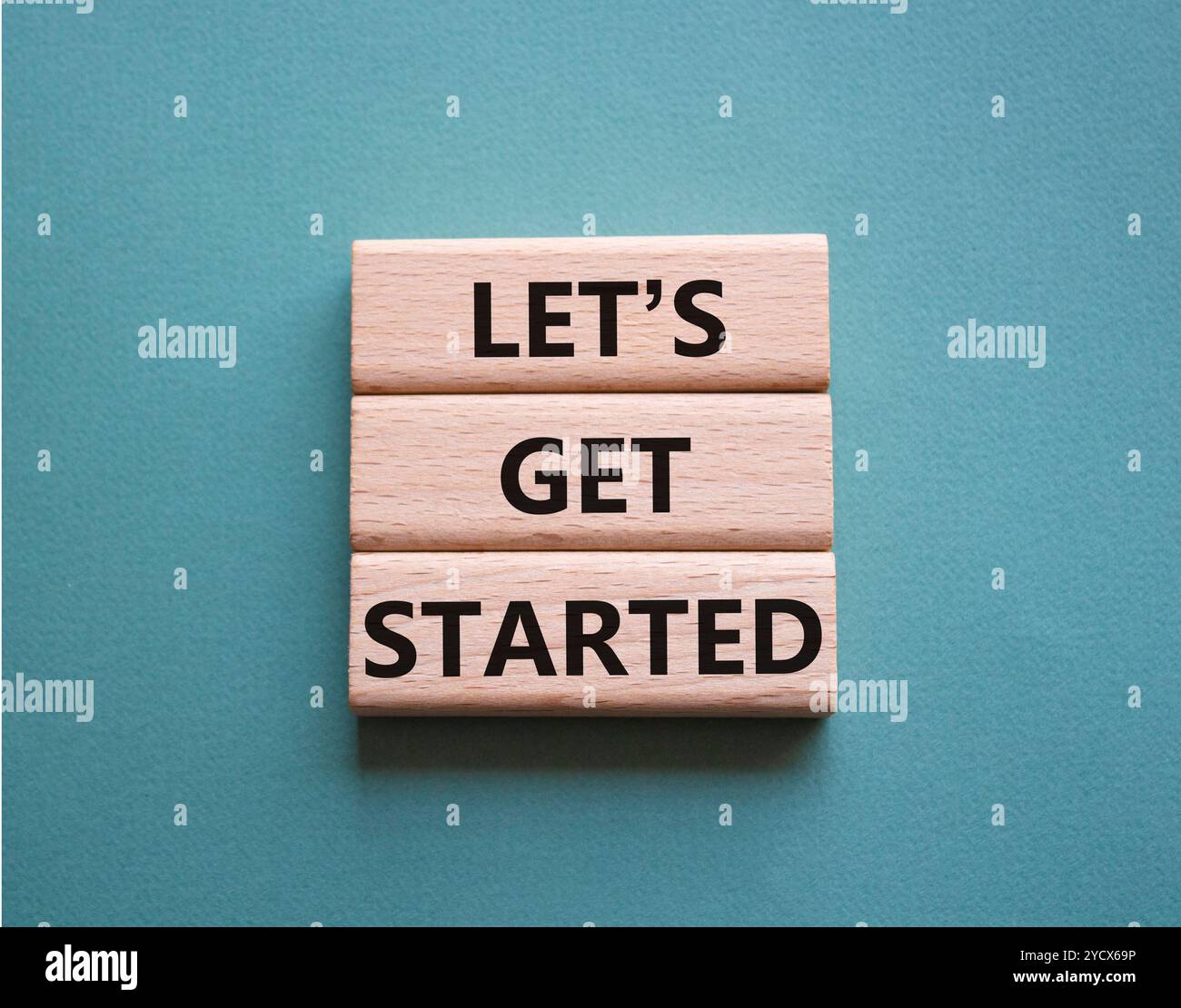 Lets get started symbol. Concept words Lets get started on wooden ...