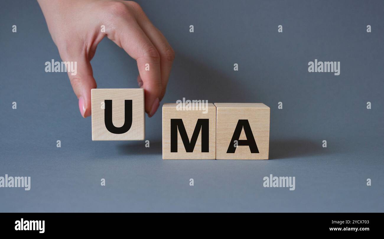 UMA - Unified Managed Account. Wooden cubes with word UMA. Businessman ...