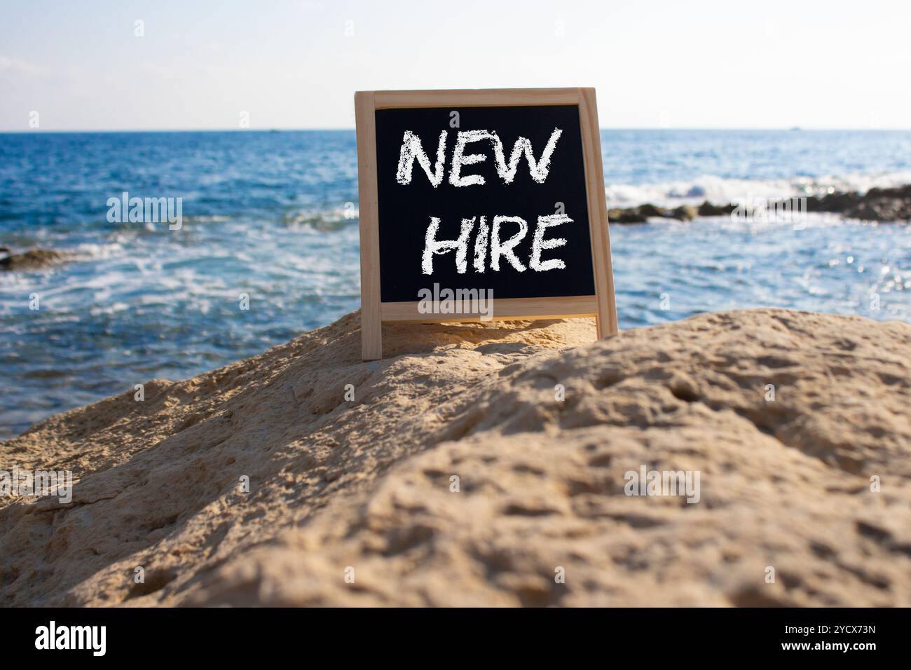 New Hire symbol. Concept words New Hire on black chalk background ...
