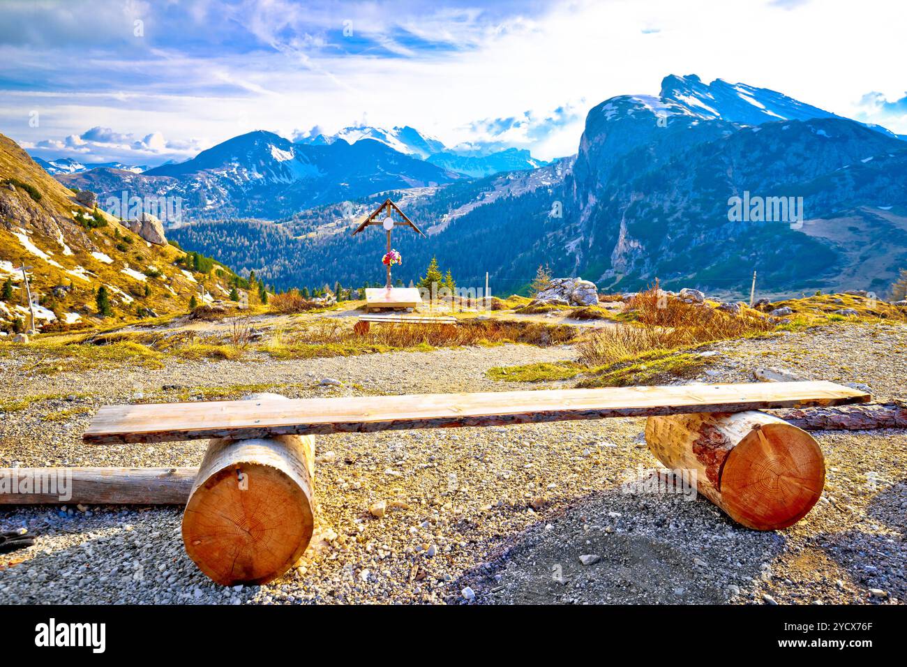Bench and cross in Valparola Pass alpine destination Stock Photo - Alamy