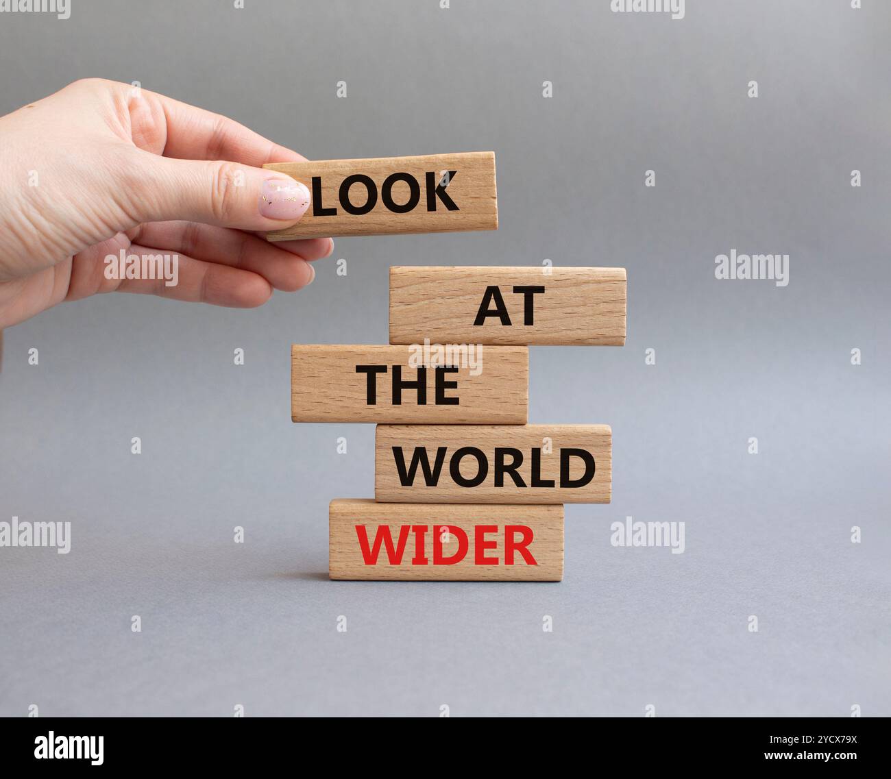 Look at the world wider symbol. Wooden blocks with words Look at the ...