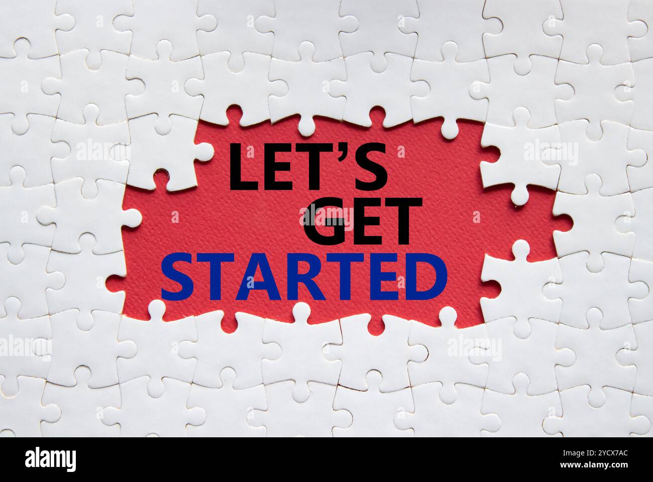 Lets get started symbol. Concept words Lets get started on white puzzle ...